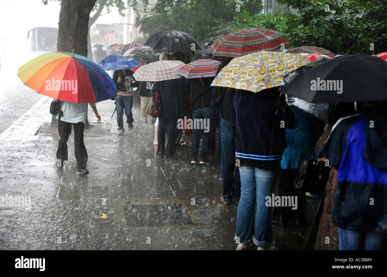 Queue people waiting in rain hi-res stock photography and images - Alamy