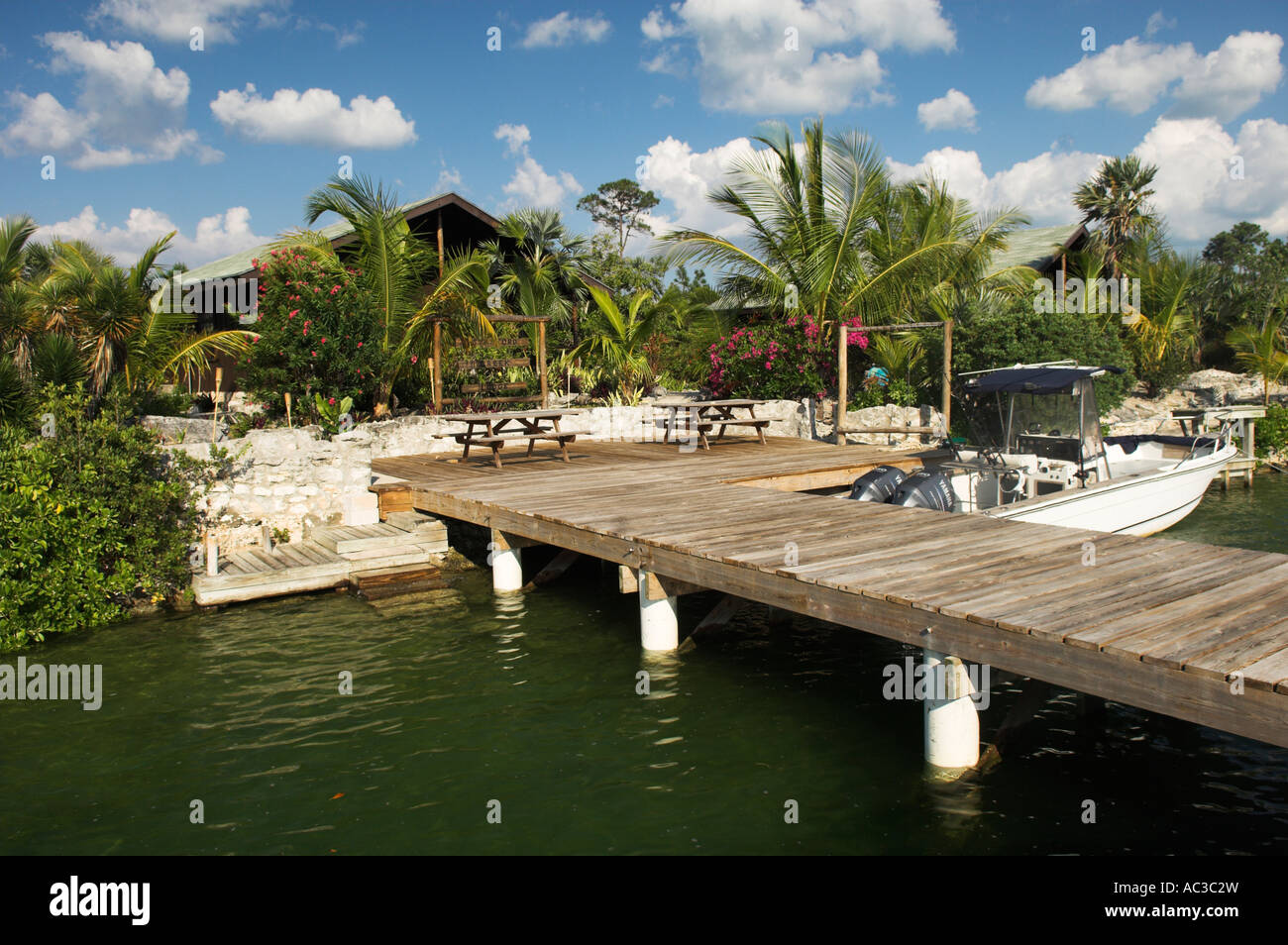 Wooden dock Stafford Creek bone fishing Lodge boat blue sky and clouds ...