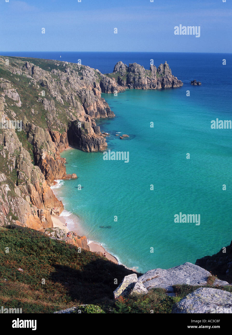 A view over Treen beach to Logan Rock, near Penzance, in Cornwall ...