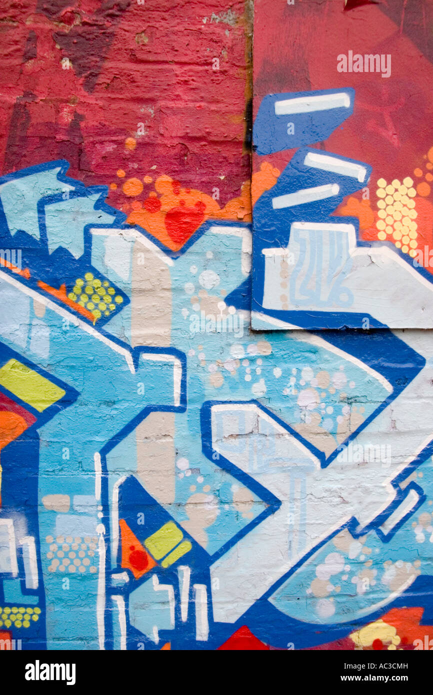 Colourful artistic graffiti painted on derelict walls on waste ground ...