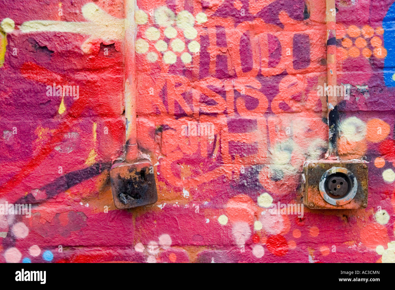 Colourful artistic graffiti painted on derelict walls on waste ground ...