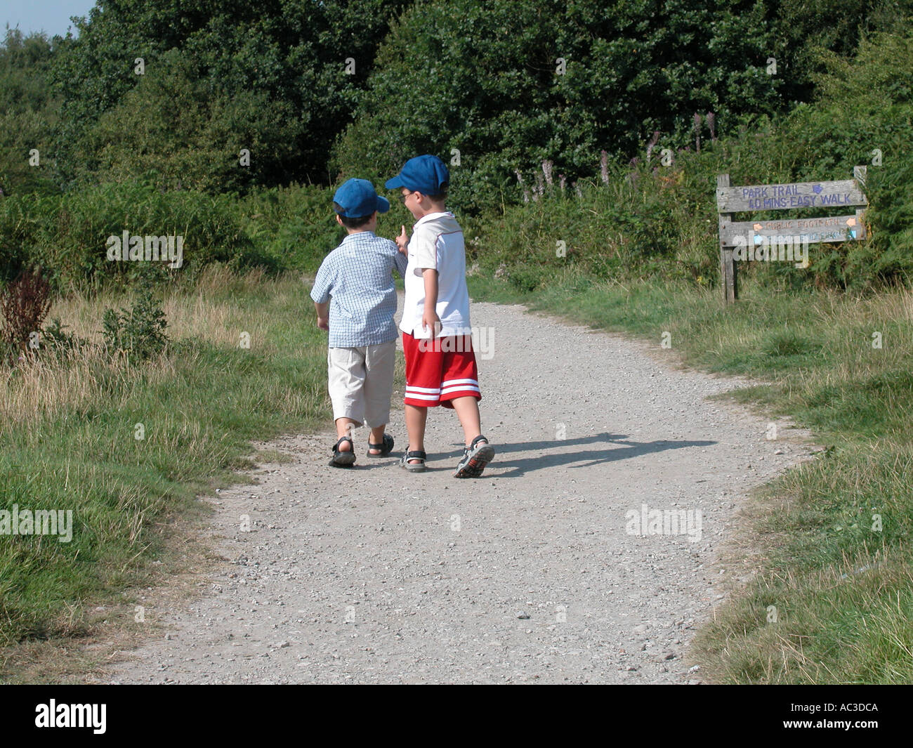 Boys walking on common woods public footpath Stock Photo - Alamy