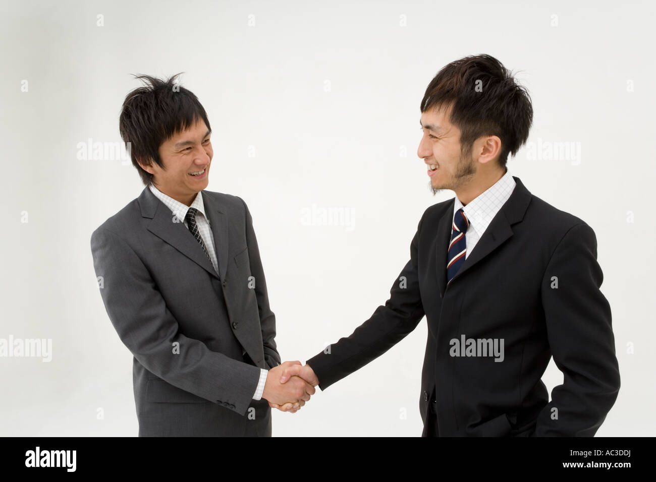 Two businessmen shaking hands Stock Photo - Alamy