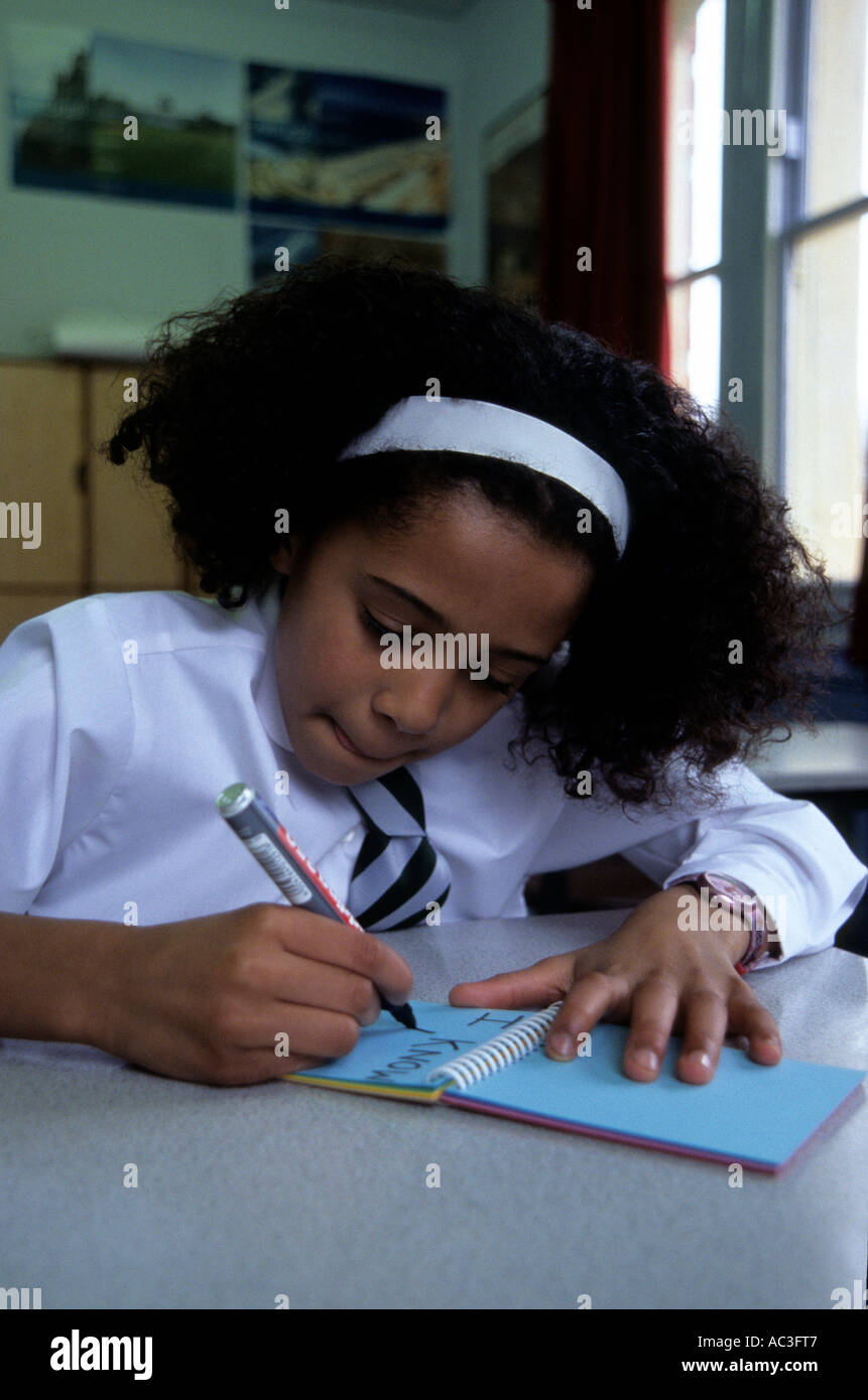 Secrecy - little black schoolgirl writing a secret note Stock Photo - Alamy