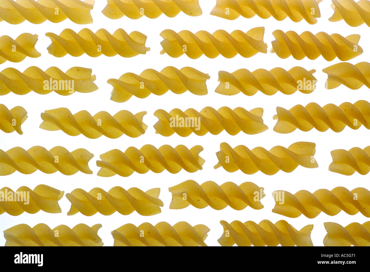 Rotini pasta in rows on a white background Stock Photo - Alamy