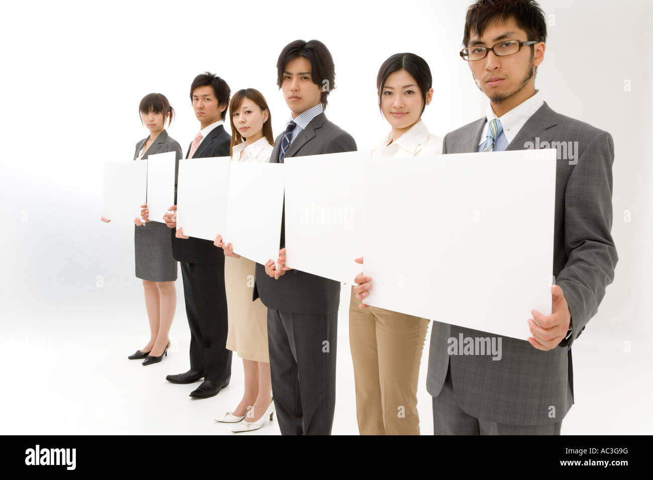 Business people holding blank placards Stock Photo - Alamy