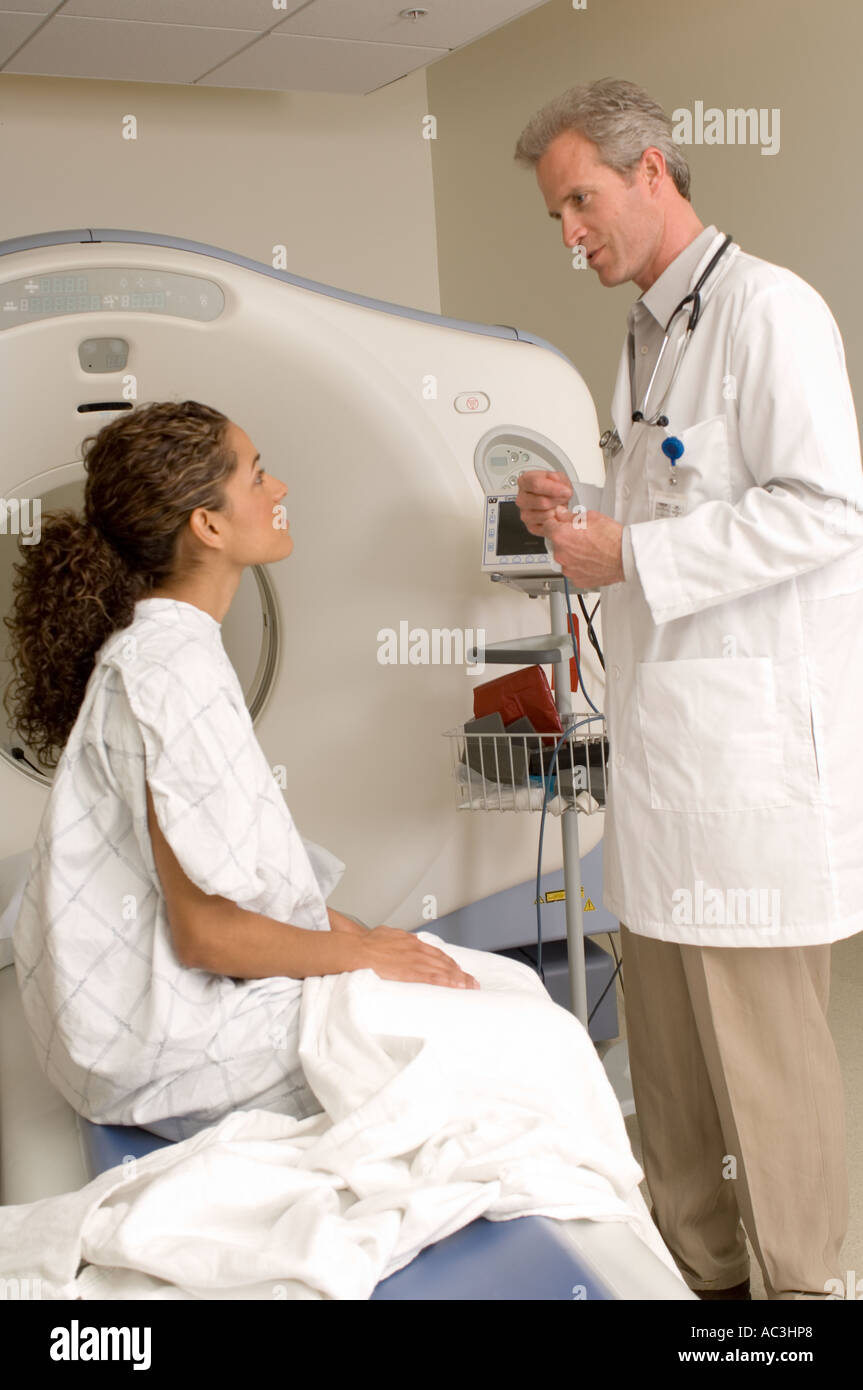 Portrait of radiologist about to perform cat scan on female patient ...