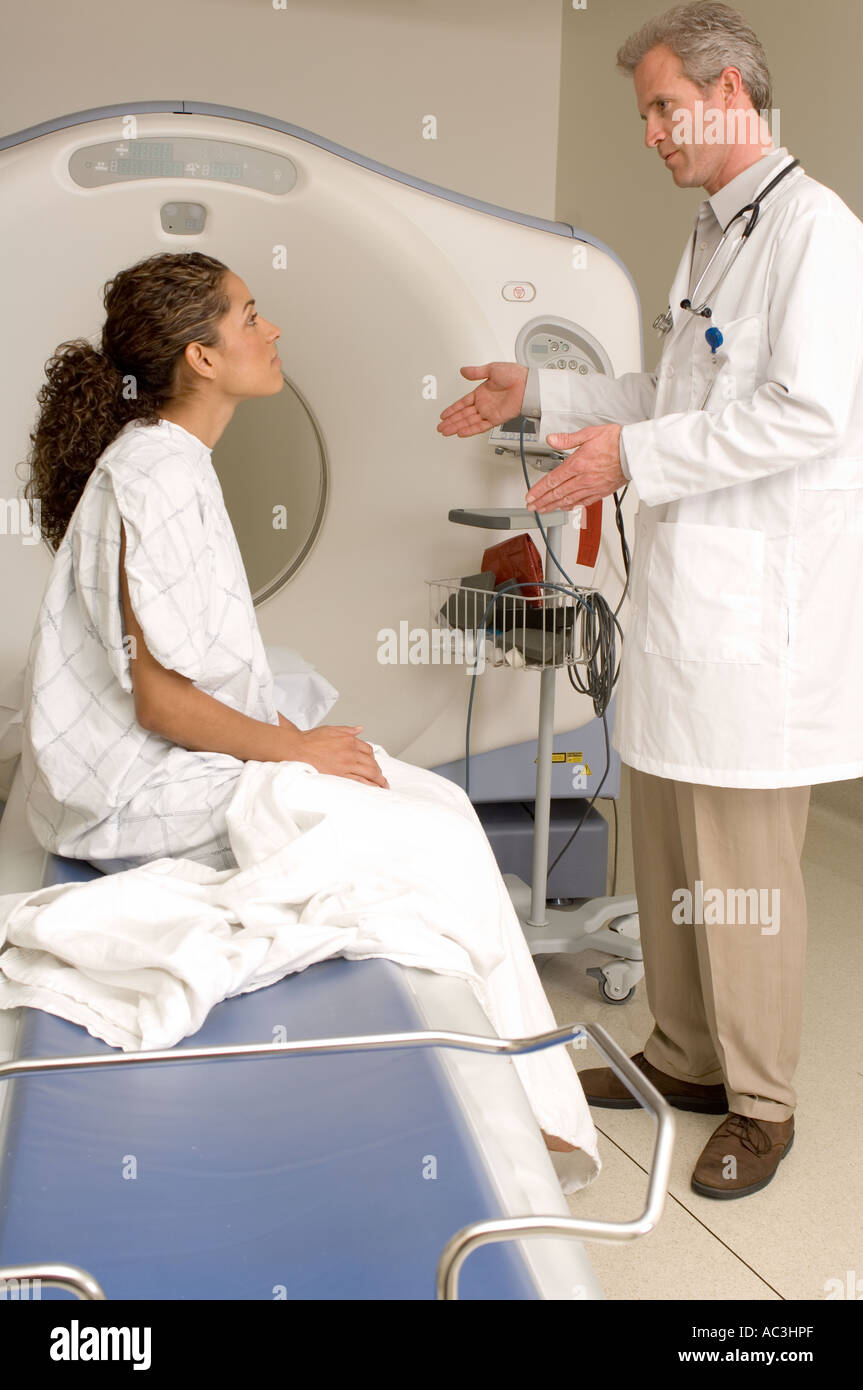 Portrait of radiologist about to perform cat scan on female patient ...