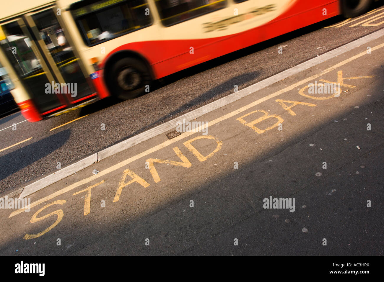 brighton bus stop road painted warning to stand back Stock Photo - Alamy