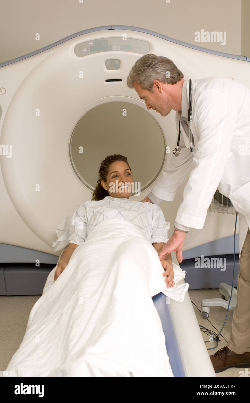 Portrait of radiologist about to perform cat scan on female patient ...