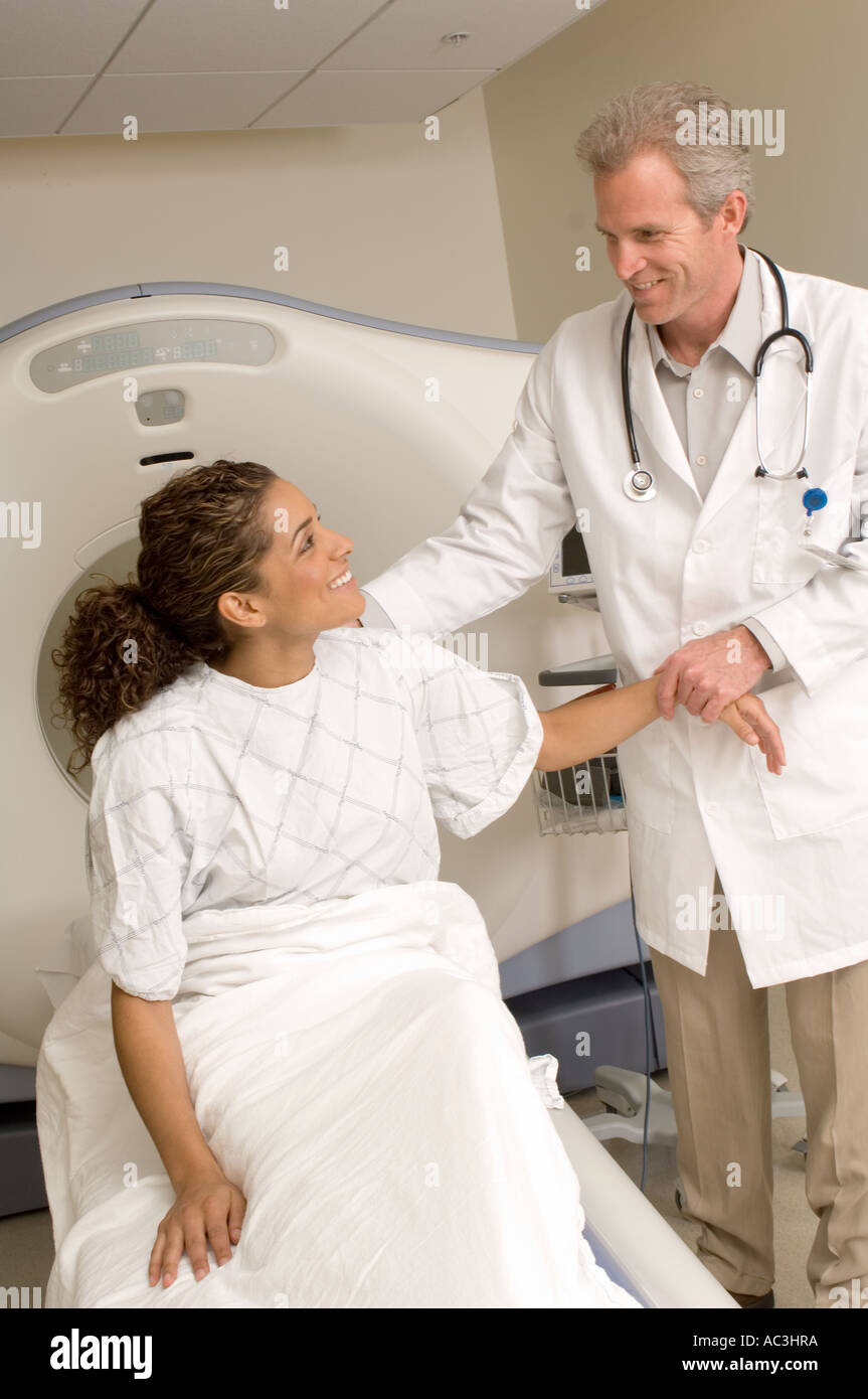 Portrait of radiologist about to perform cat scan on female patient ...