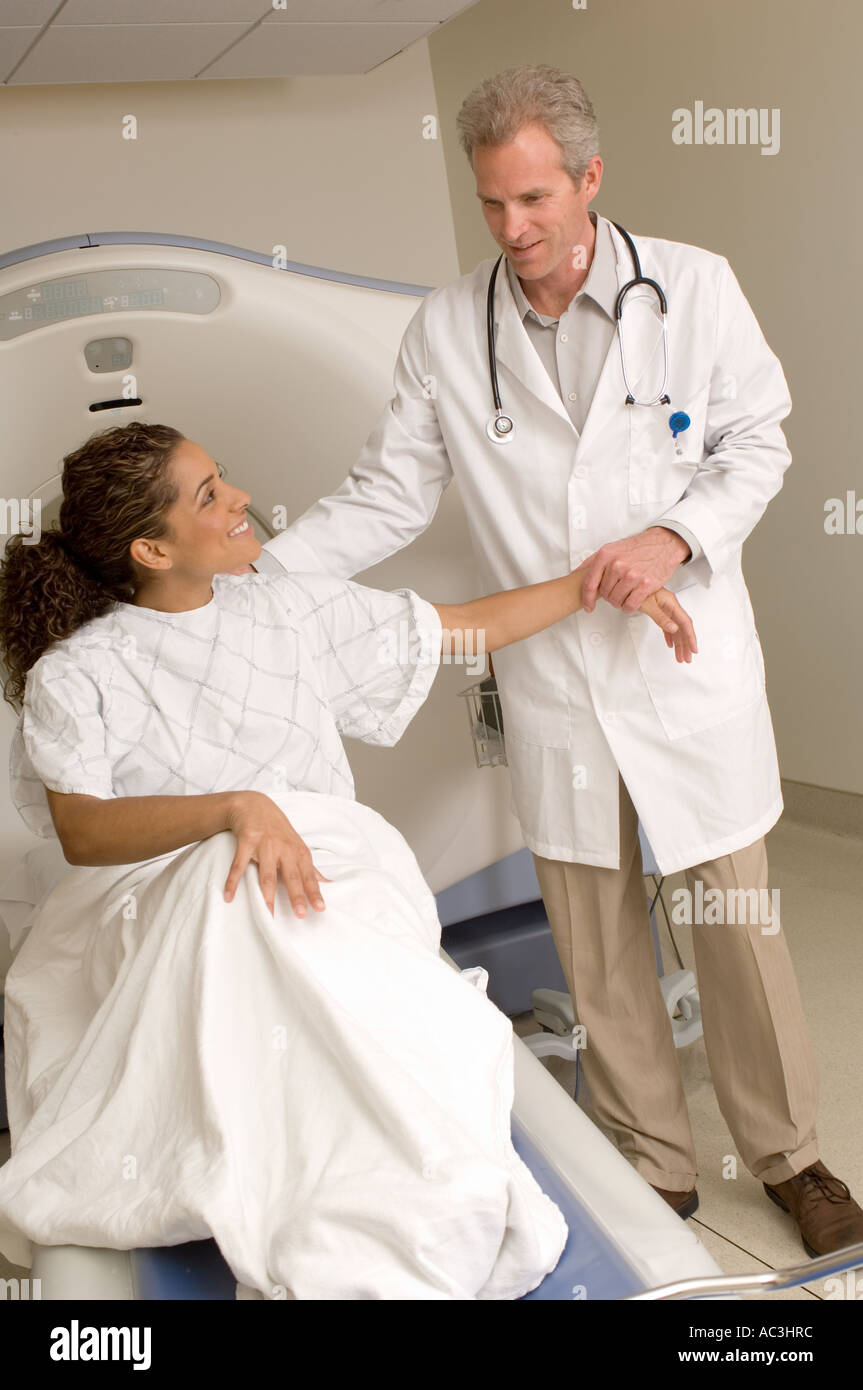 Portrait of radiologist about to perform cat scan on female patient ...