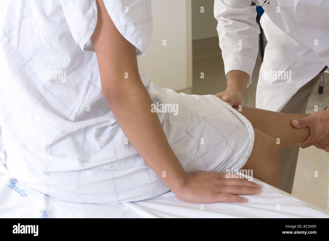 Portrait of doctor examining patient's leg Stock Photo - Alamy