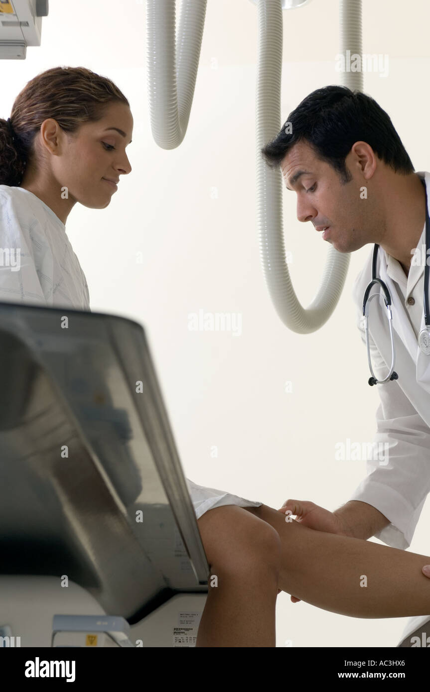 Portrait of doctor examining patient's leg Stock Photo - Alamy