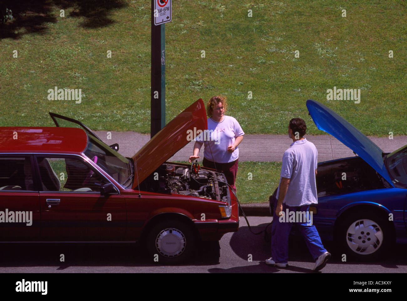A Car stalled on a Road gets a Boost from another Car Stock Photo - Alamy