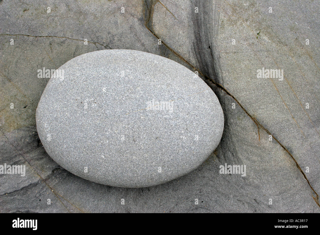 Pebble on a Rock Stock Photo - Alamy