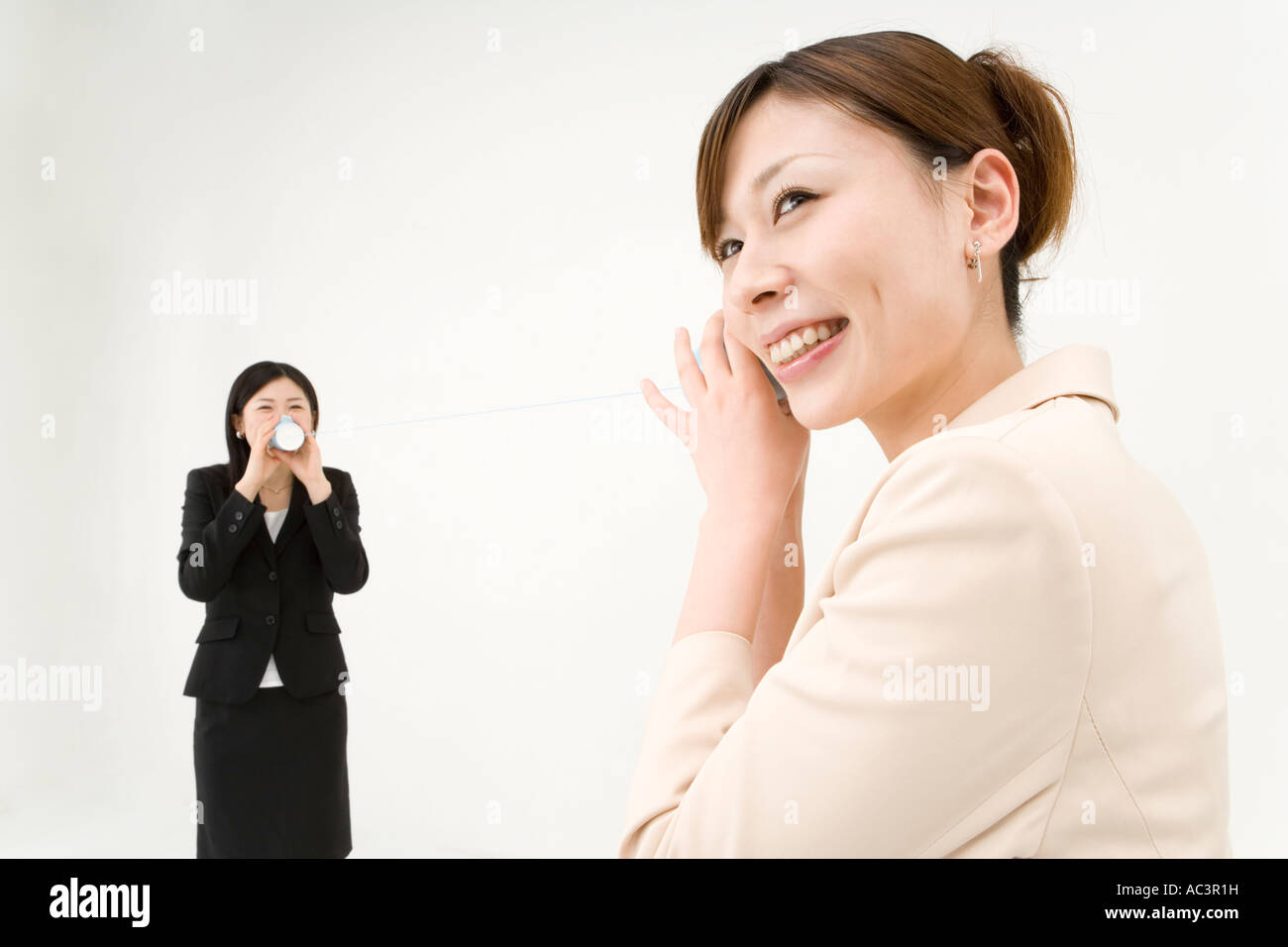 Standing talking holding cups hi-res stock photography and images - Alamy