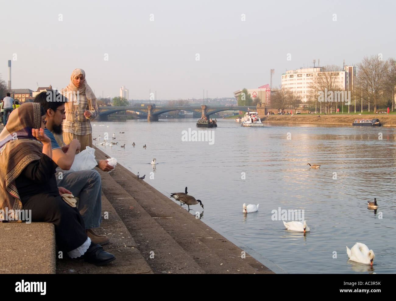 A family feeding the birds by the River Trent, at Victoria Embankment ...