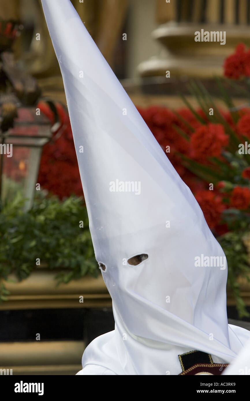 White hooded penitent during Easter religious procession, Semana Santa ...