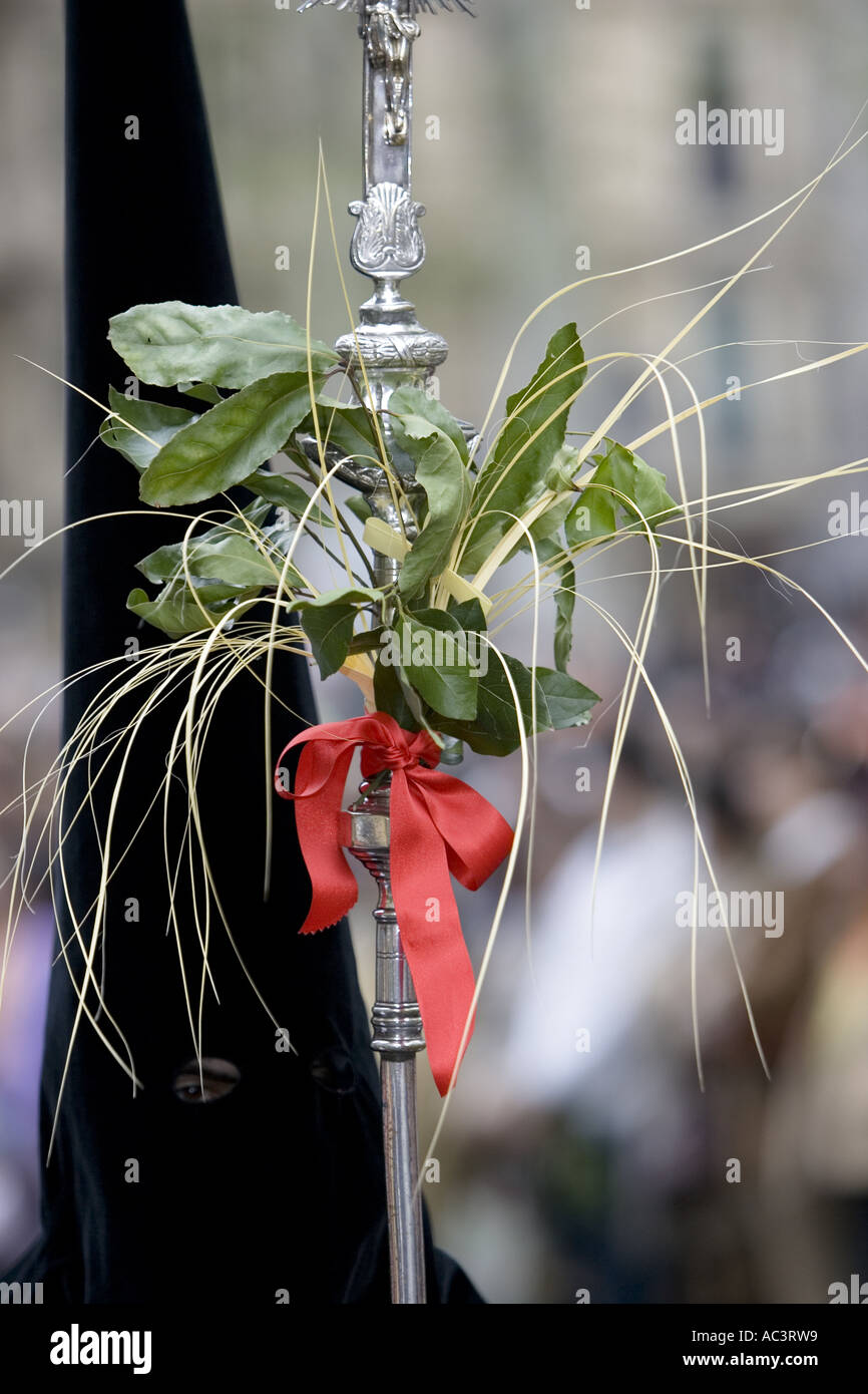 Man wearing black peaked hood, during Palm Sunday Easter religious ...