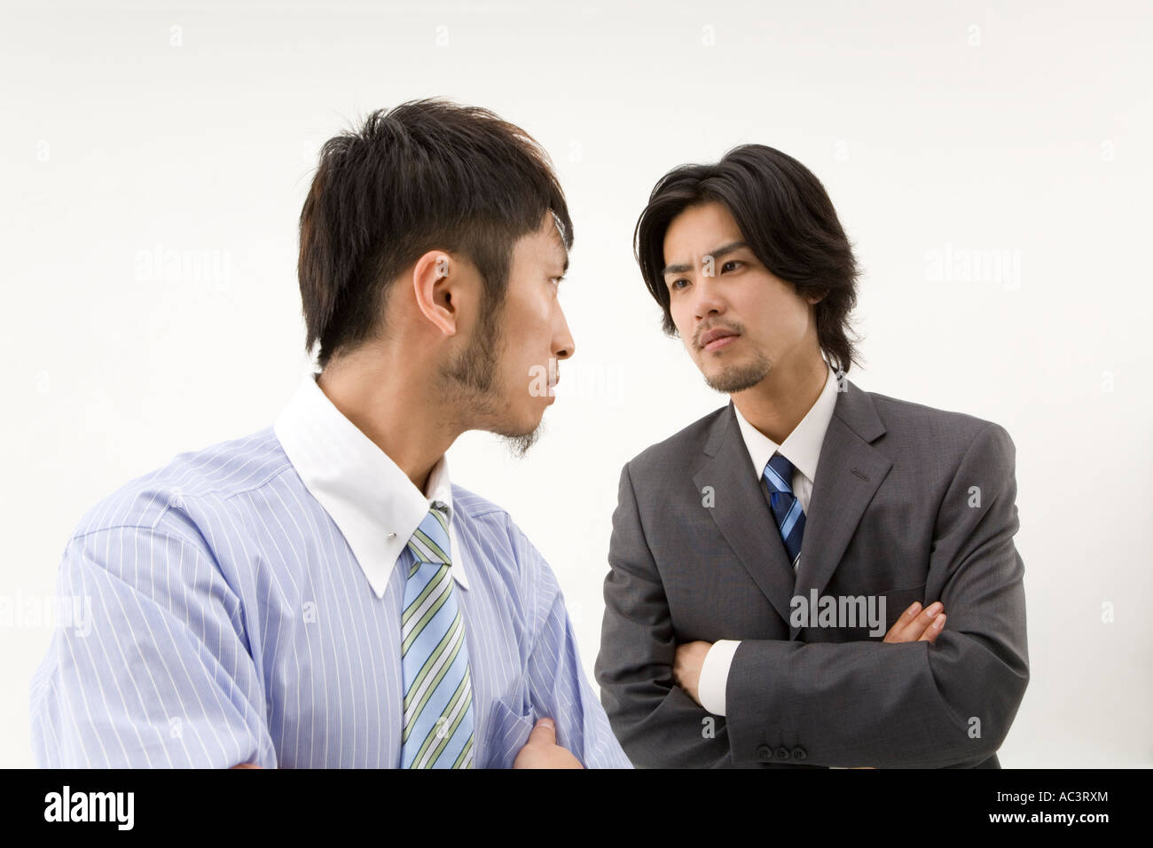 Two businessmen glaring at each other Stock Photo - Alamy