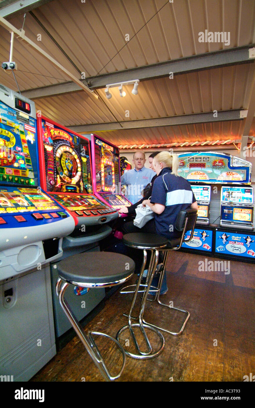 Amusement arcade sea side one arm bandit slot machine gamble woman ...