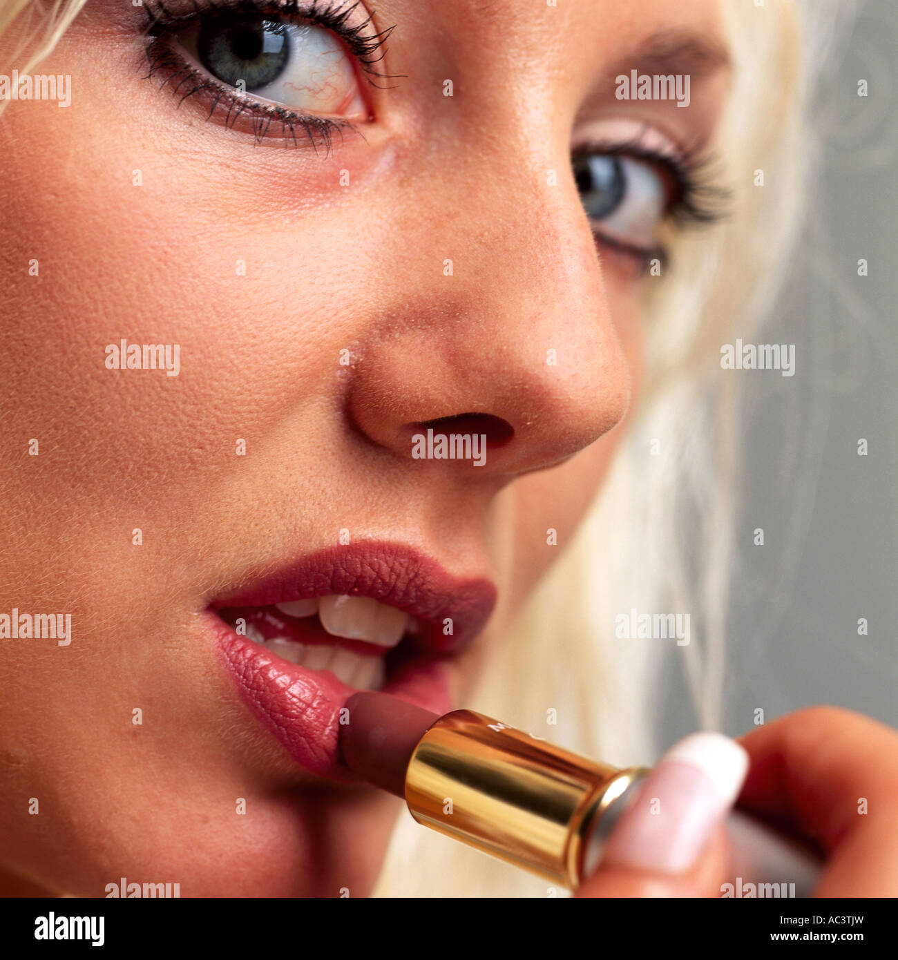 Young Woman Applying Lipstick Model Released Stock Photo - Alamy
