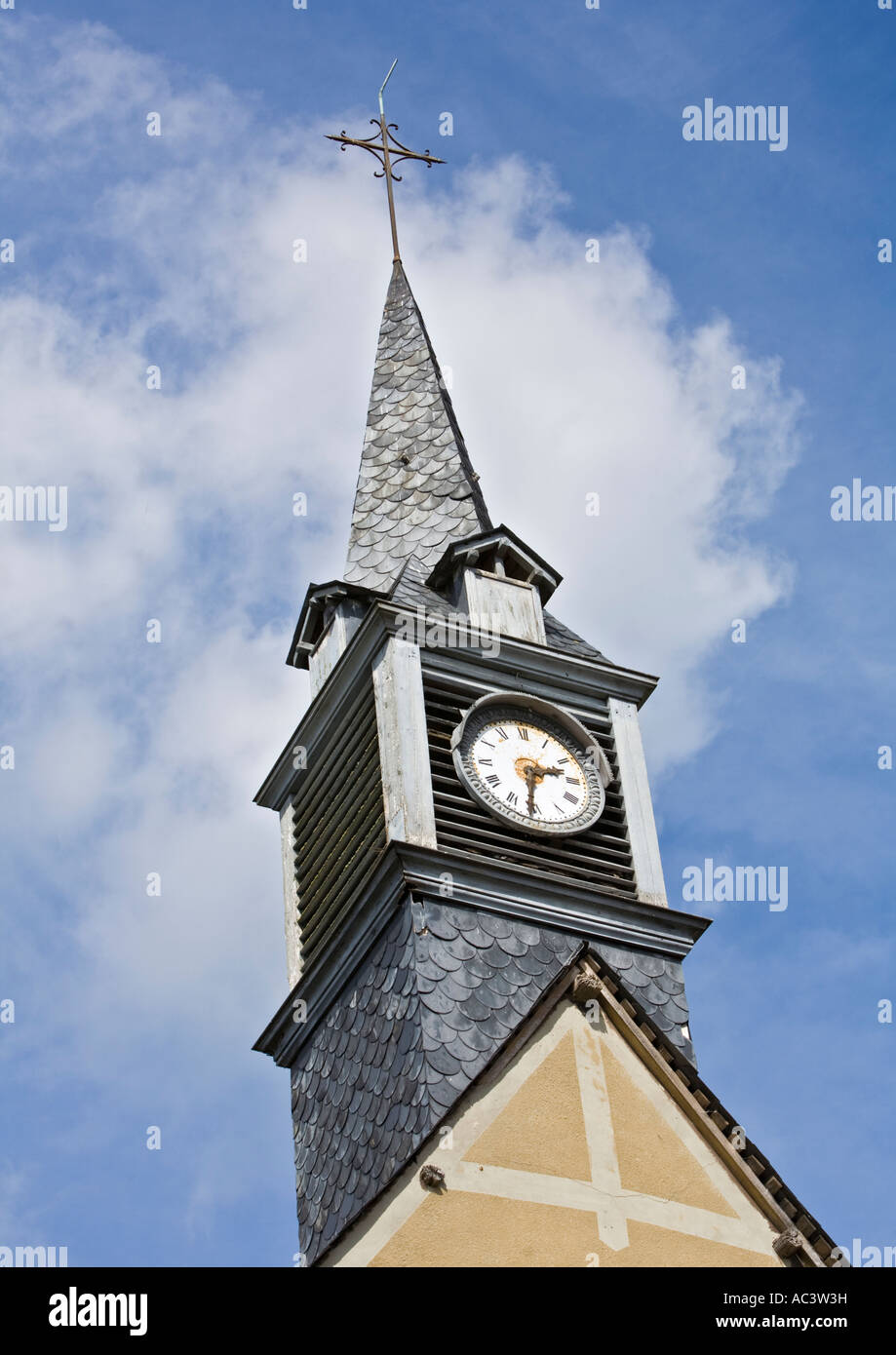 Clock tower and tiled church steeple, leaning back and low angle view ...