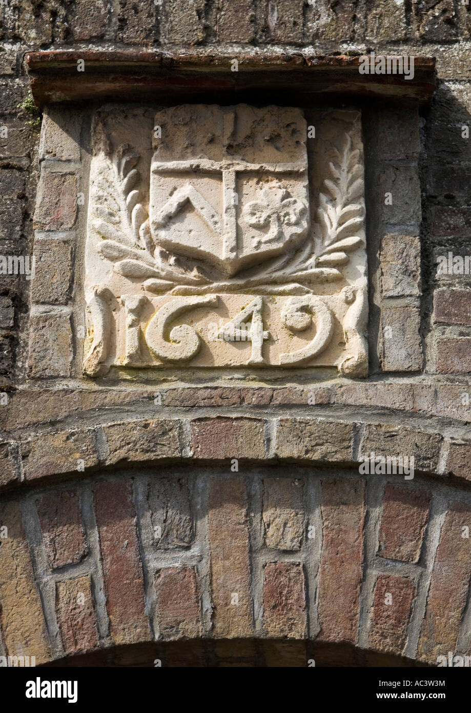 1649 date stone above romanesque brick arch Stock Photo - Alamy