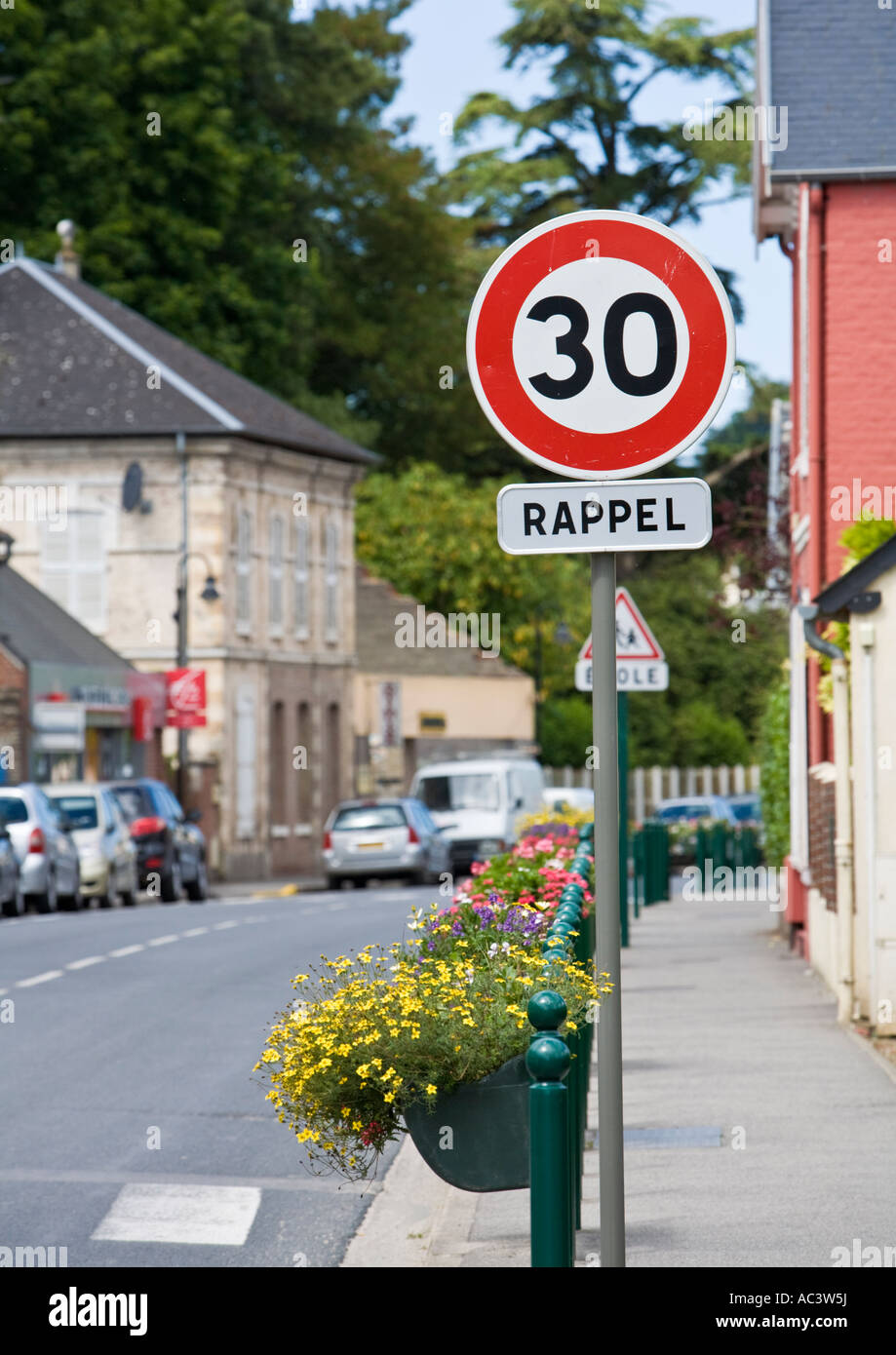 French Road speed sign 30 rappel, on pavement at side of road with ...