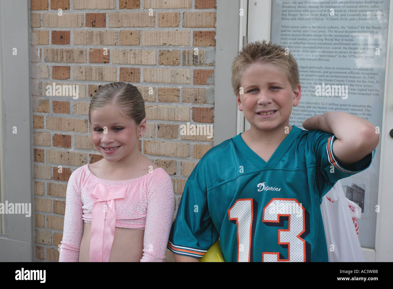 Young pretty girl poses after her dance recital with her football fan ...