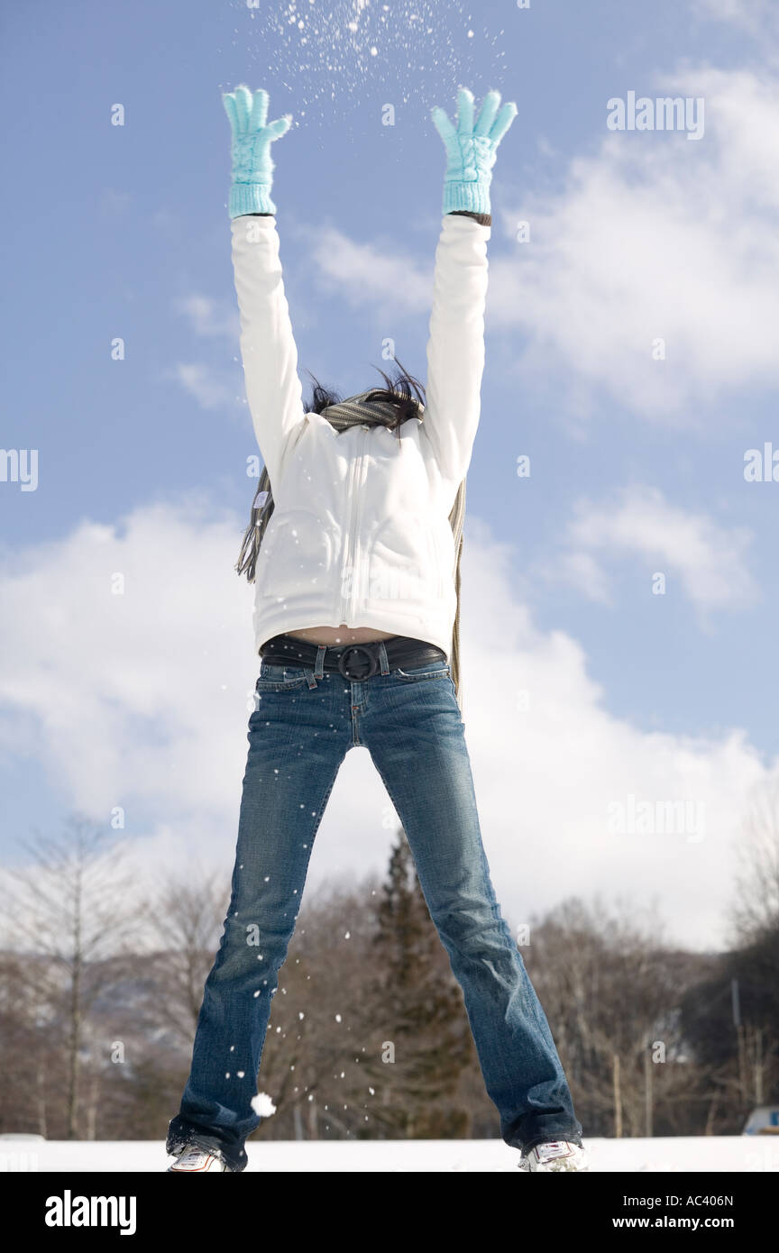 Young woman throwing snow Stock Photo - Alamy