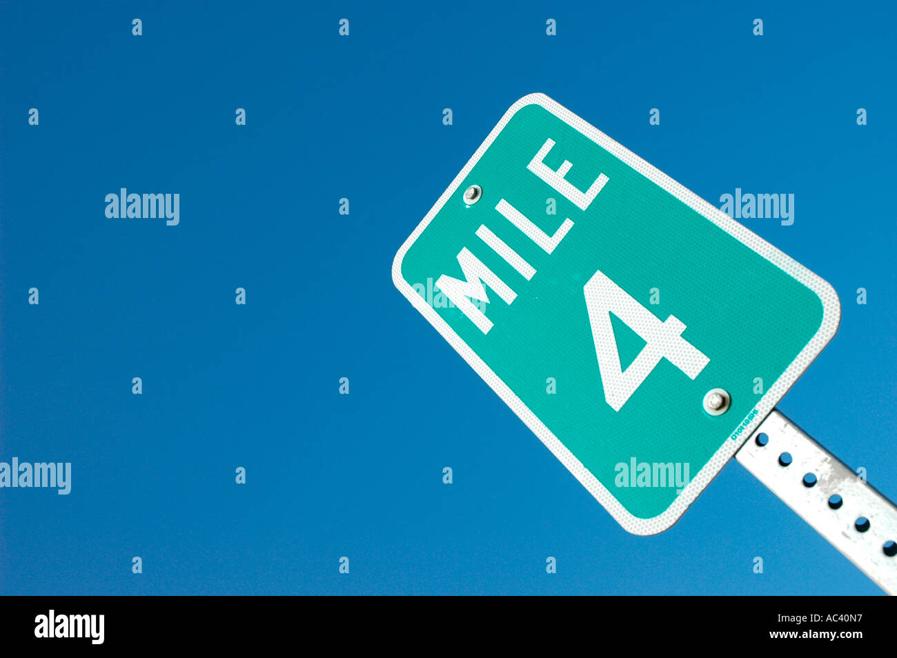 4 mile distance marker sign on freeway highway Stock Photo - Alamy