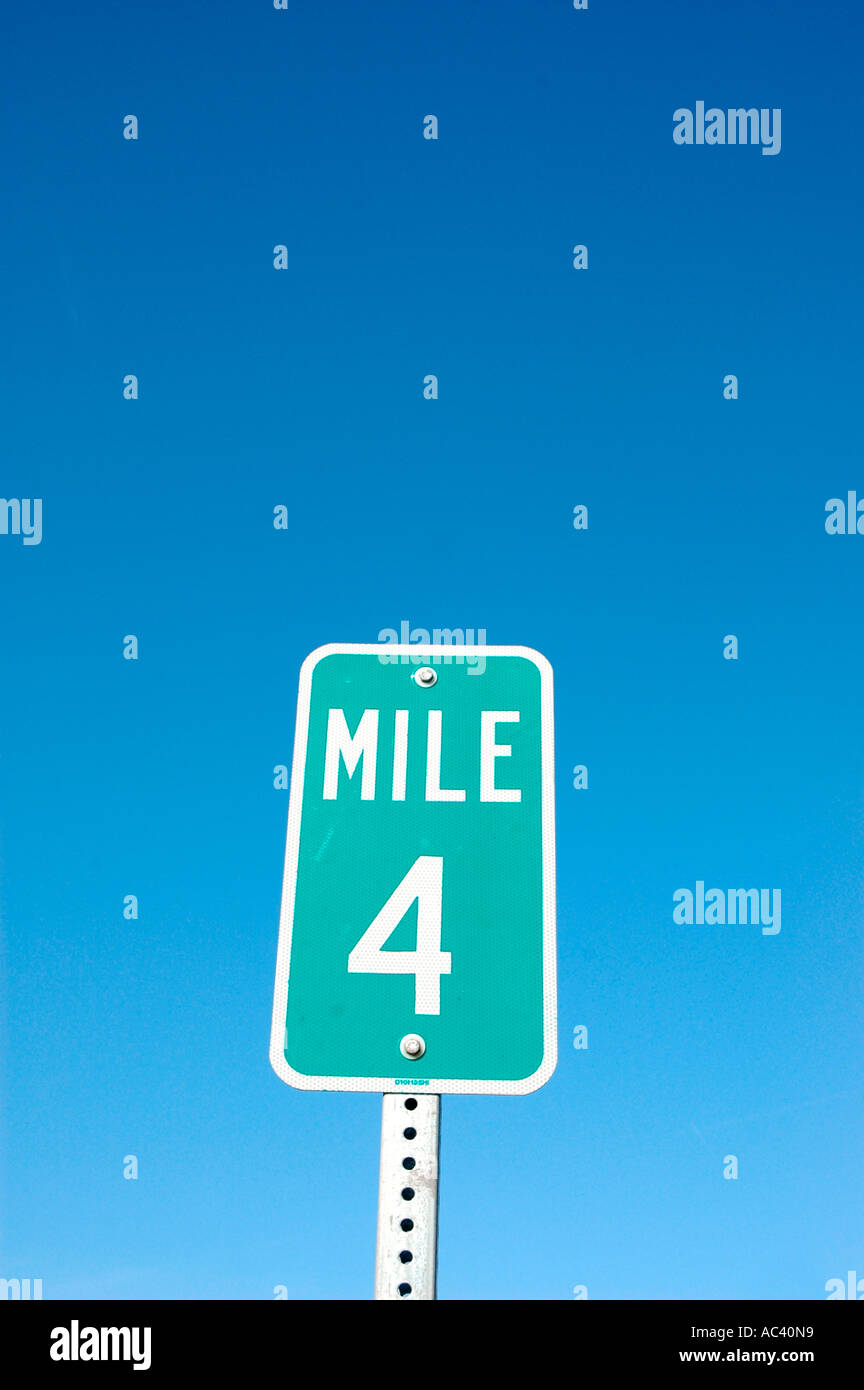 4 mile distance marker sign on freeway highway Stock Photo - Alamy