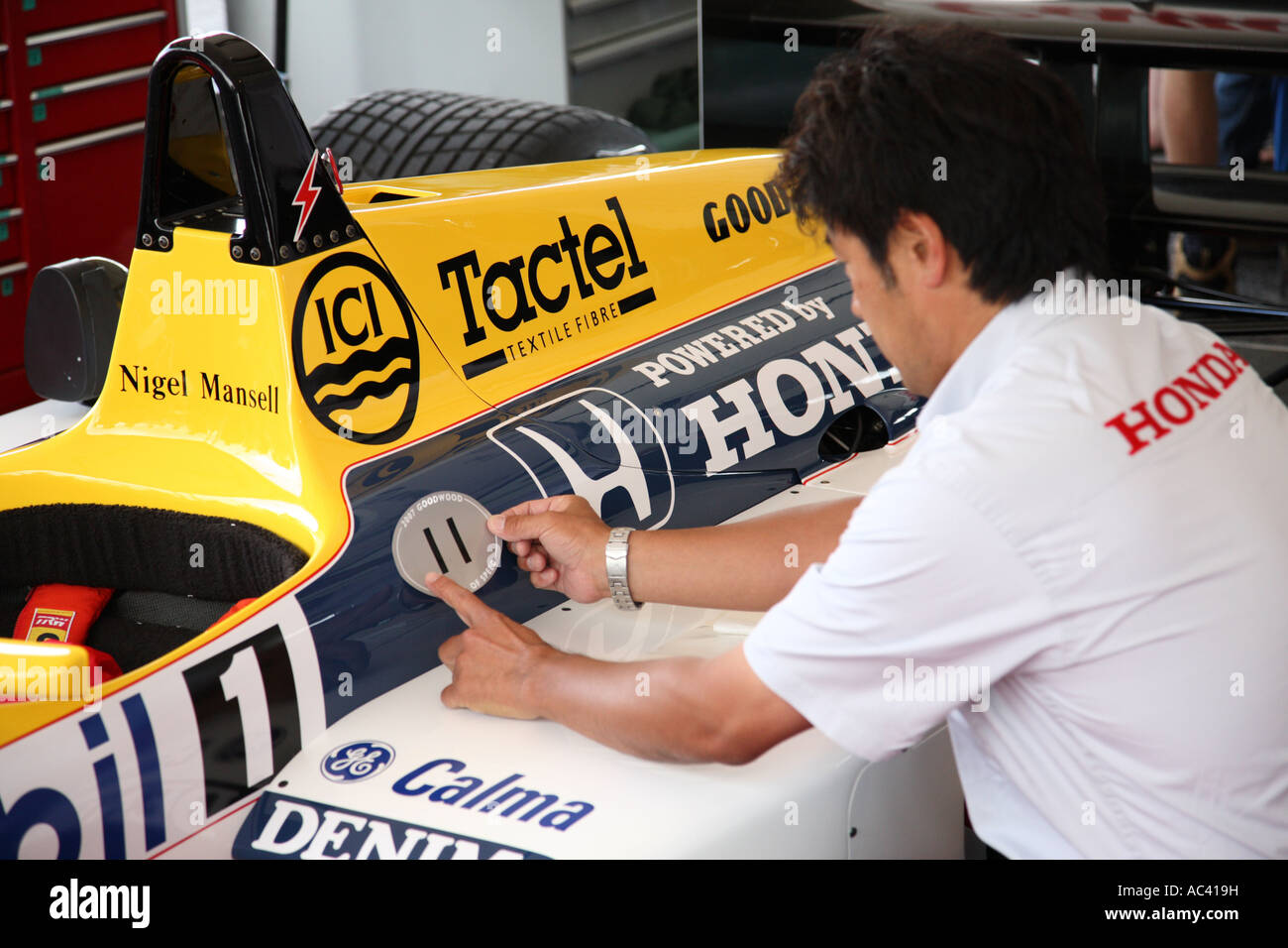 Applying an exhibiton sticker to a Williams Honda F1 car ,Goodwood ...