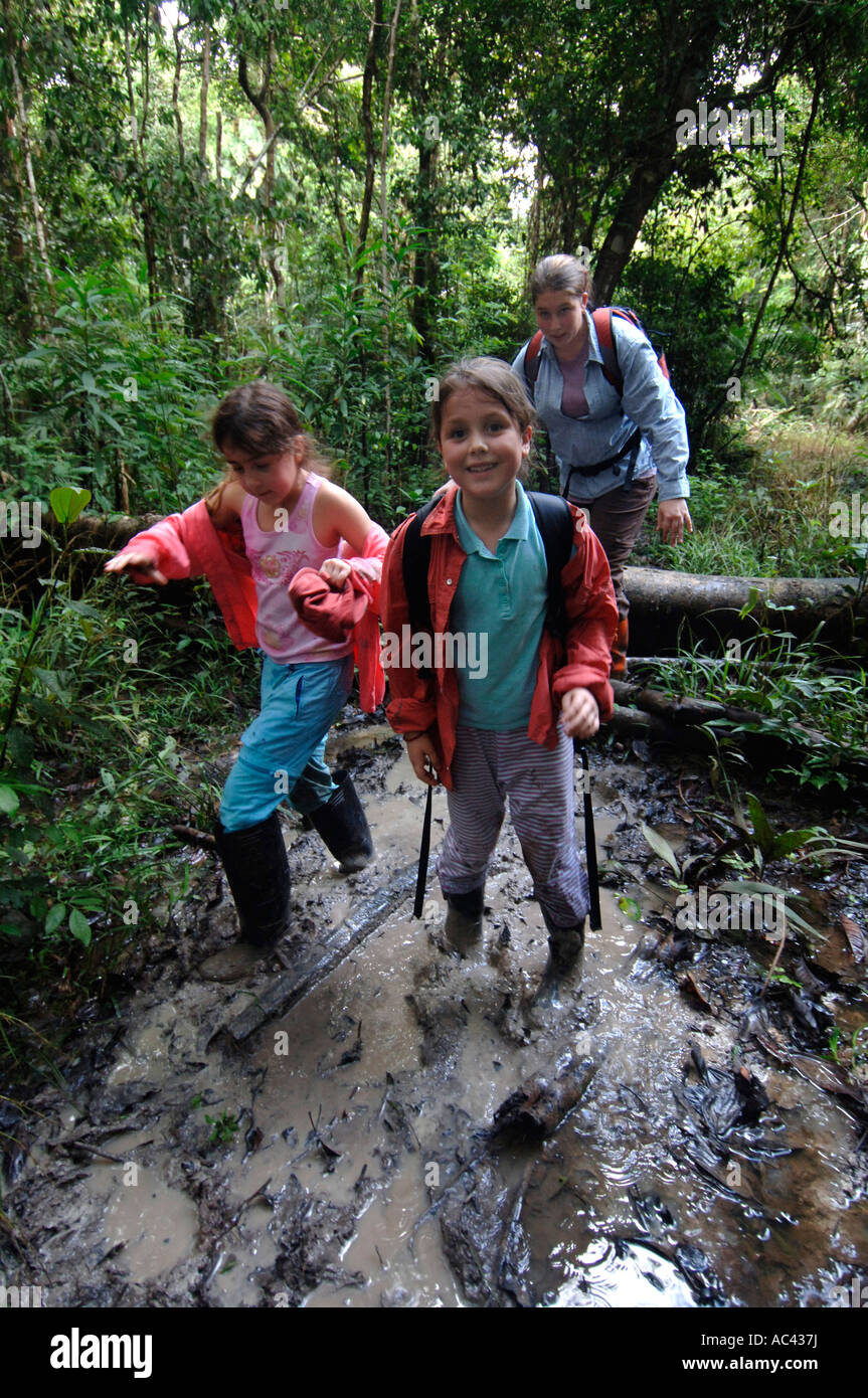 Peru Adventure vacation American girls tromp through mud on rainforest ...