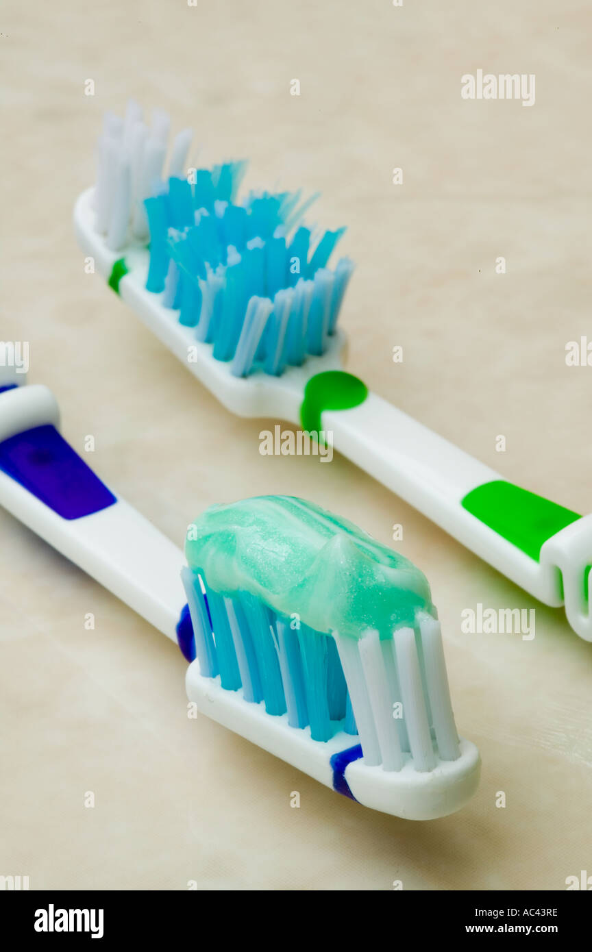 a pair of tooth brushes with toothpaste on Stock Photo - Alamy