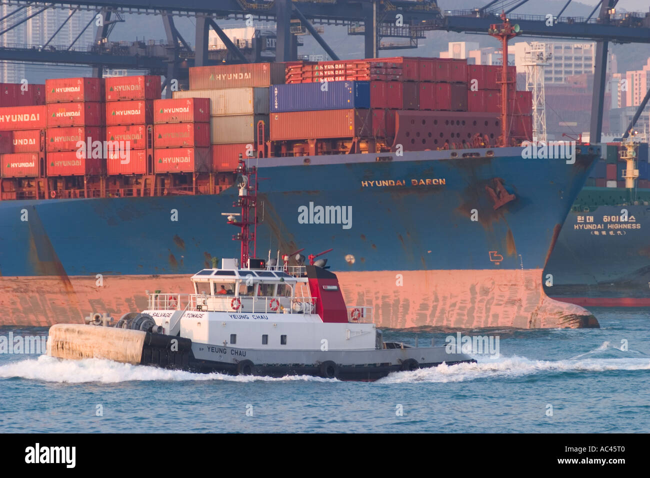 Massive Container ship heads our from Kwai Chung Port fully loaded tug ...