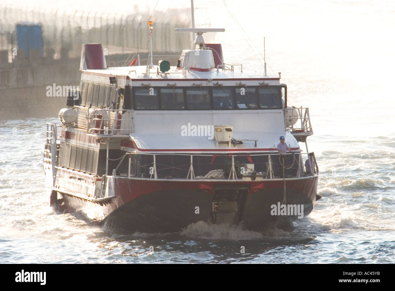 Hong Kong Macau Jetfoil entering Shun Tak Centre ferry terminal with ...