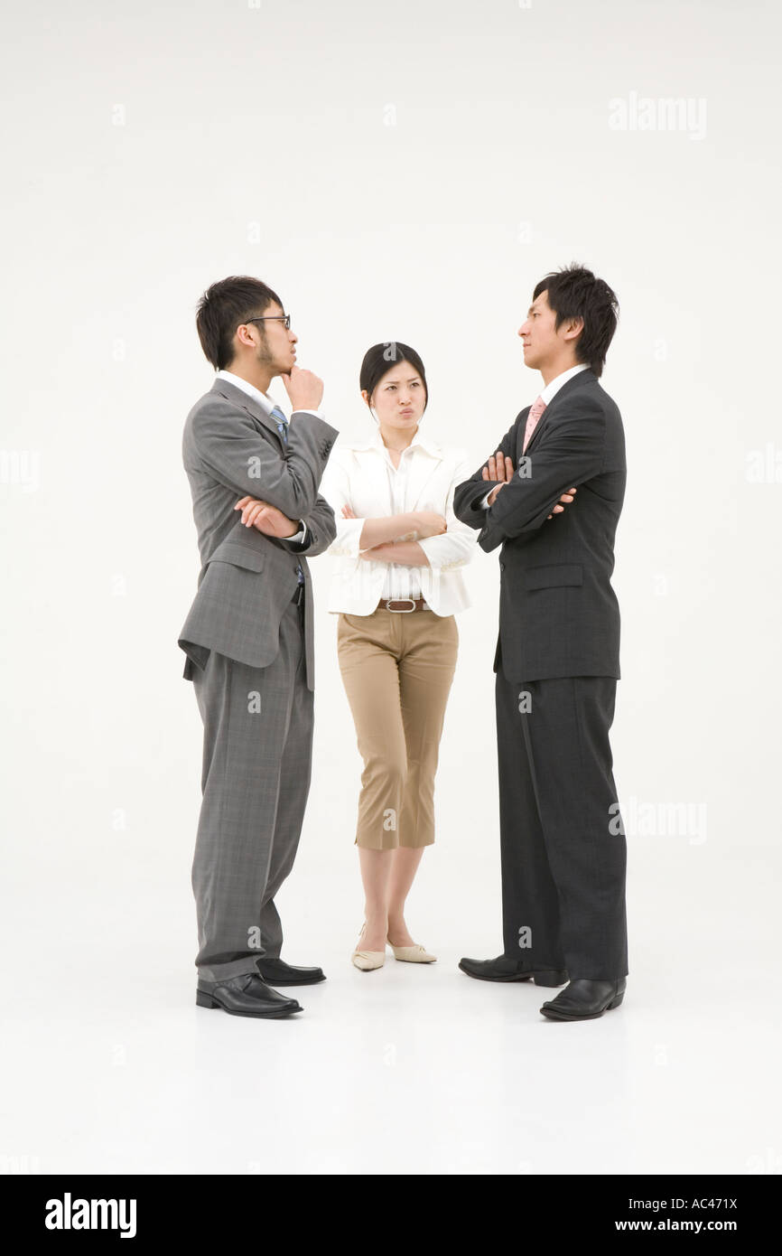 Three business people glaring at each other Stock Photo - Alamy