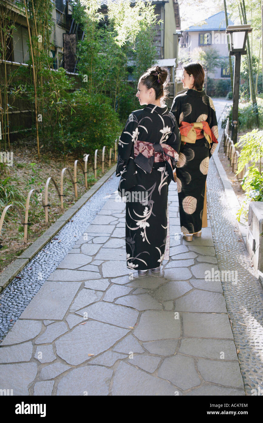 Two young women in kimono walking rear view Stock Photo - Alamy