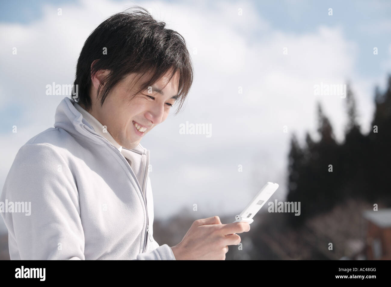 Young man using mobile phone Stock Photo - Alamy