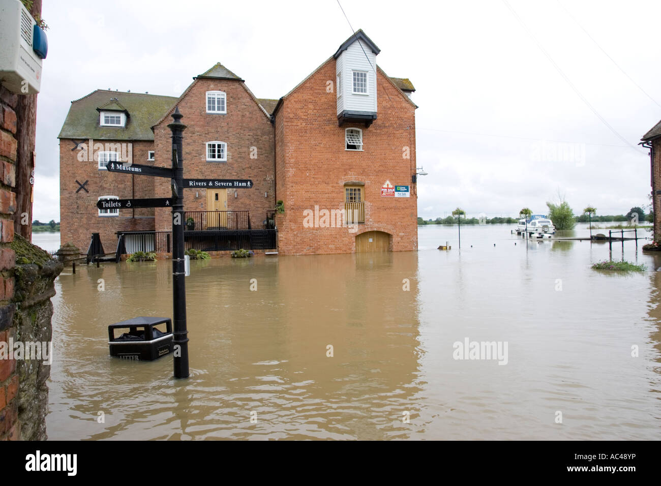 Abbey Mill surrounded by flood River Avon opposite Tewkesbury Abbey ...