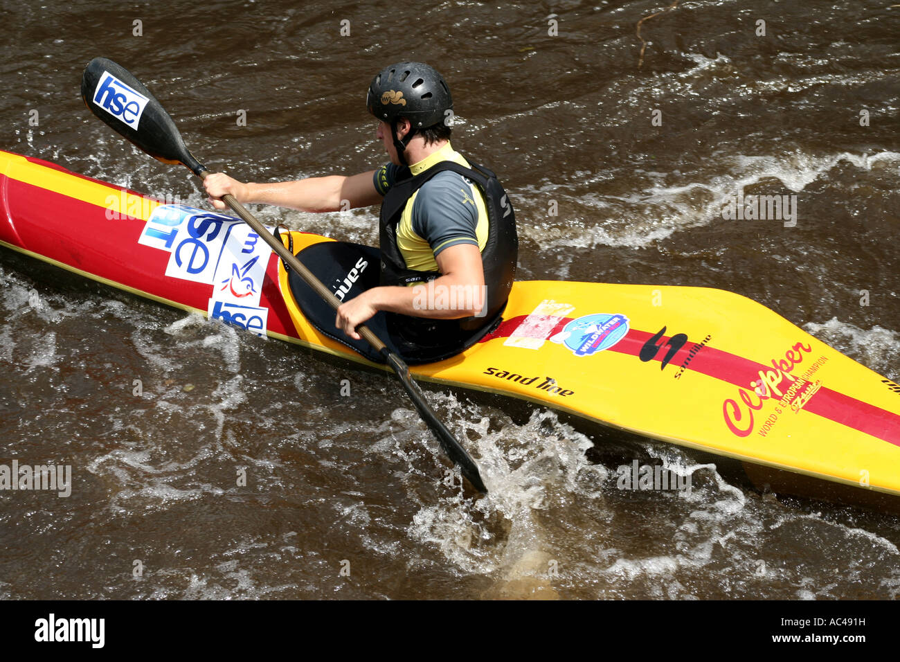 A kayaker maneuvers through the turbulent waters of a river in Karlovy ...