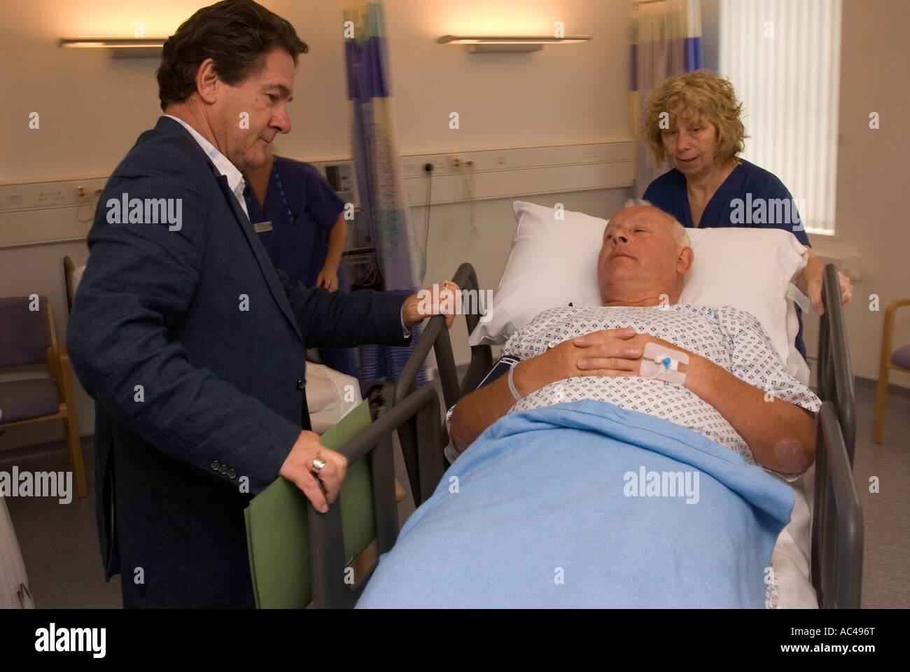 Patient being overseen by GP in recovery room following an operation at ...