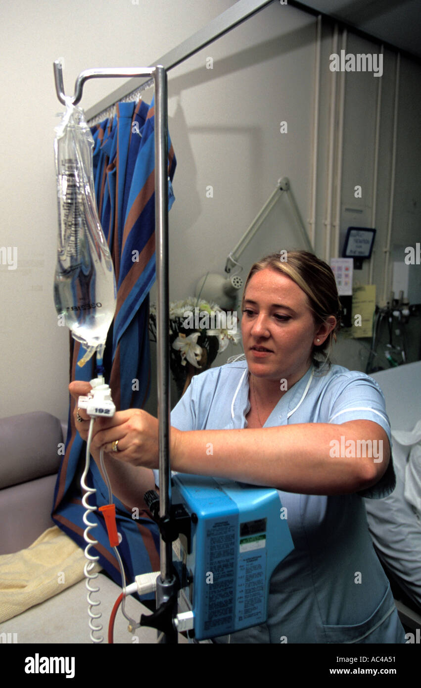 Nurse on geriatric ward checking patients drip, London, England Stock ...