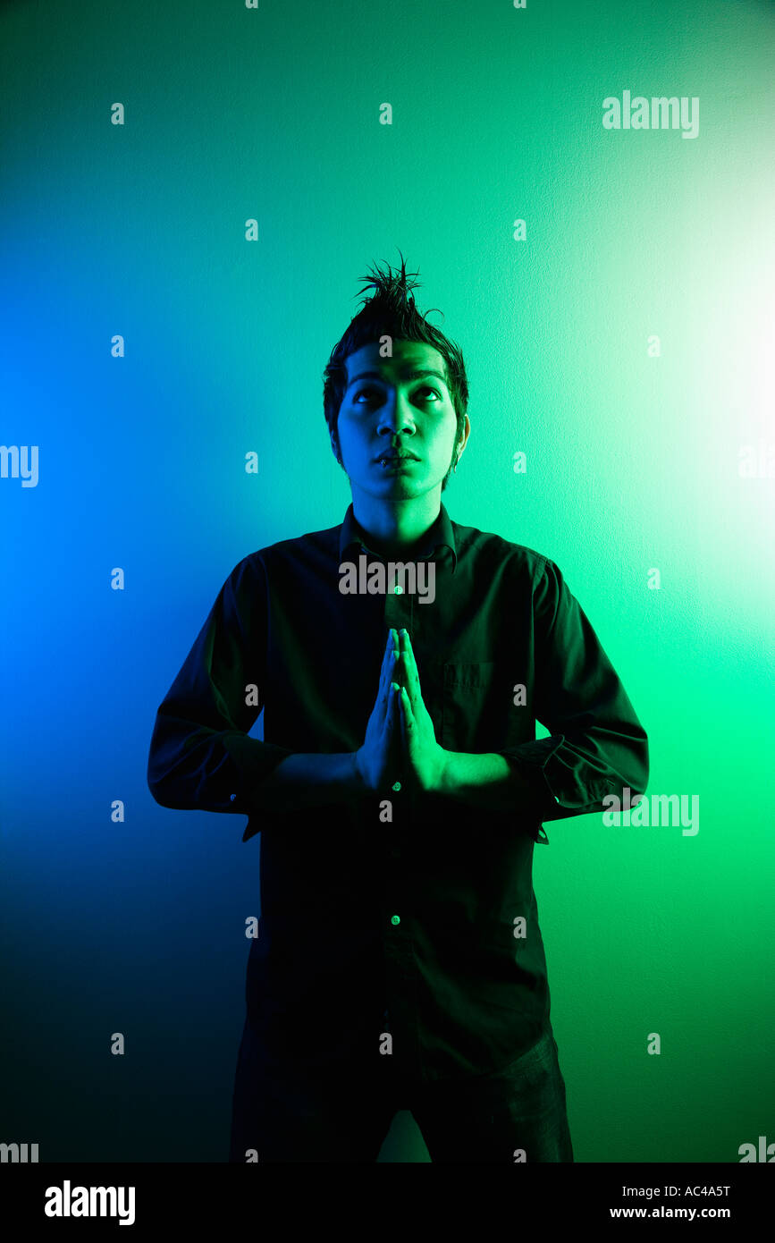 Portrait of attractive young Asian Filipino man standing holding hands ...