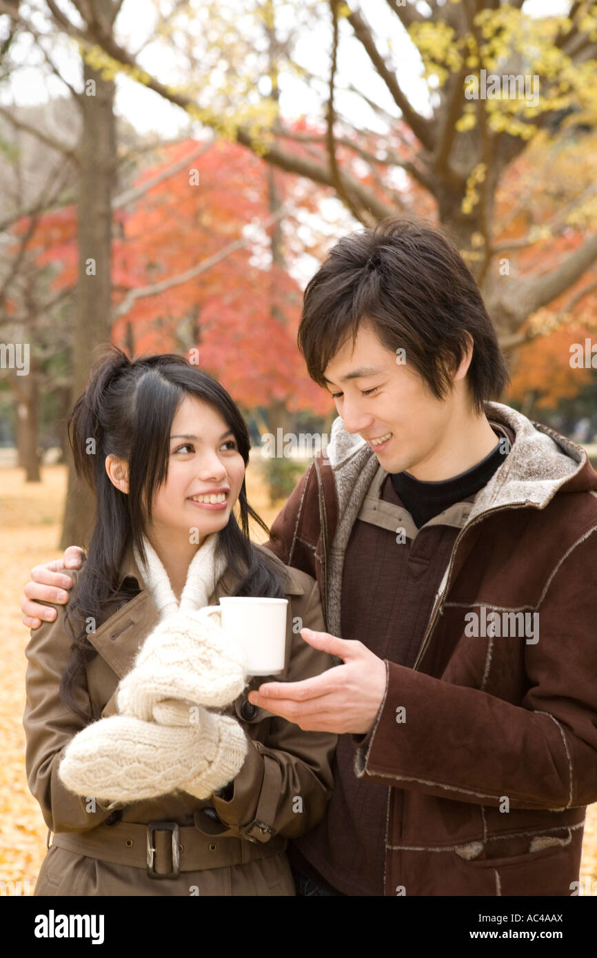 Young couple sharing cup of coffee Stock Photo - Alamy