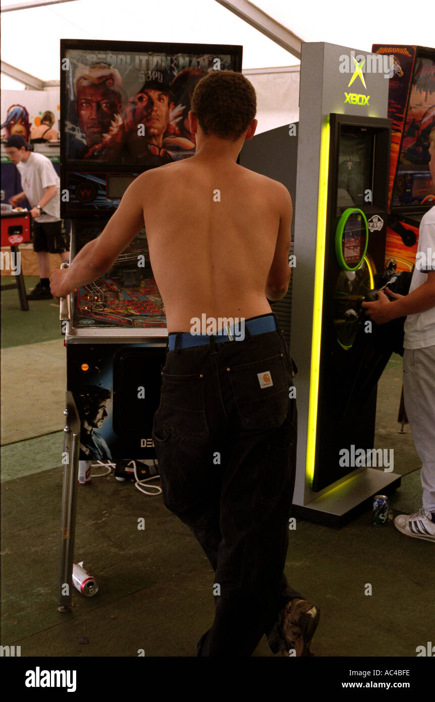 Young man playing pinball machine hi-res stock photography and images ...