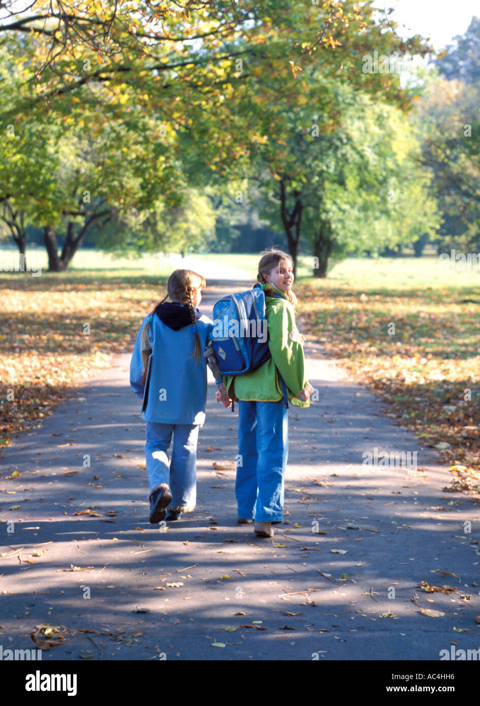Two girls walking to school Stock Photo - Alamy